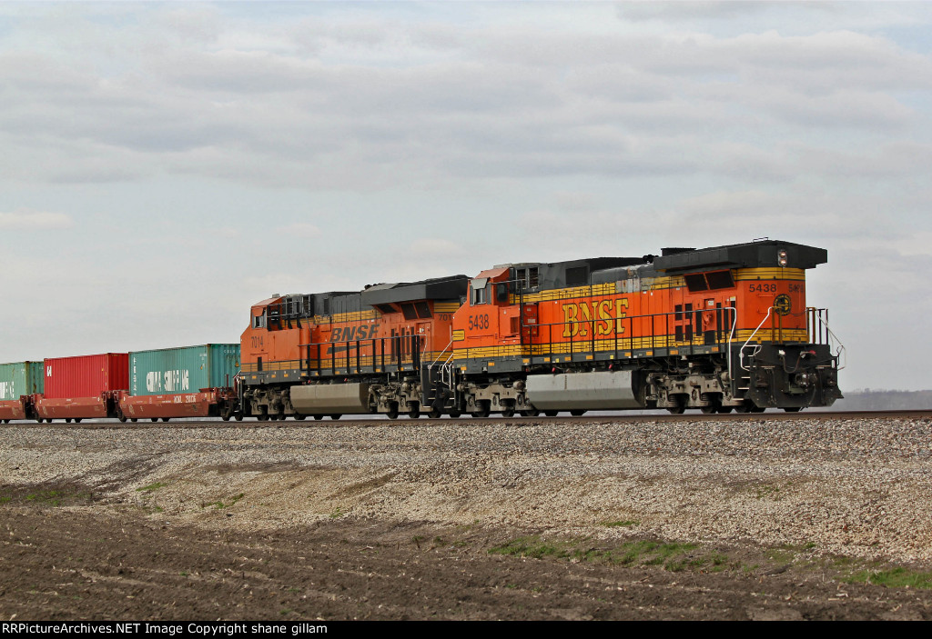 BNSF 5438 and Bnsf 7014 shove hard on a Wb stack train.
